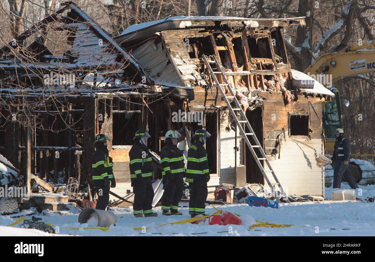 Fire fighters and Ontario Fire Marshall officials attend the scene of a ...