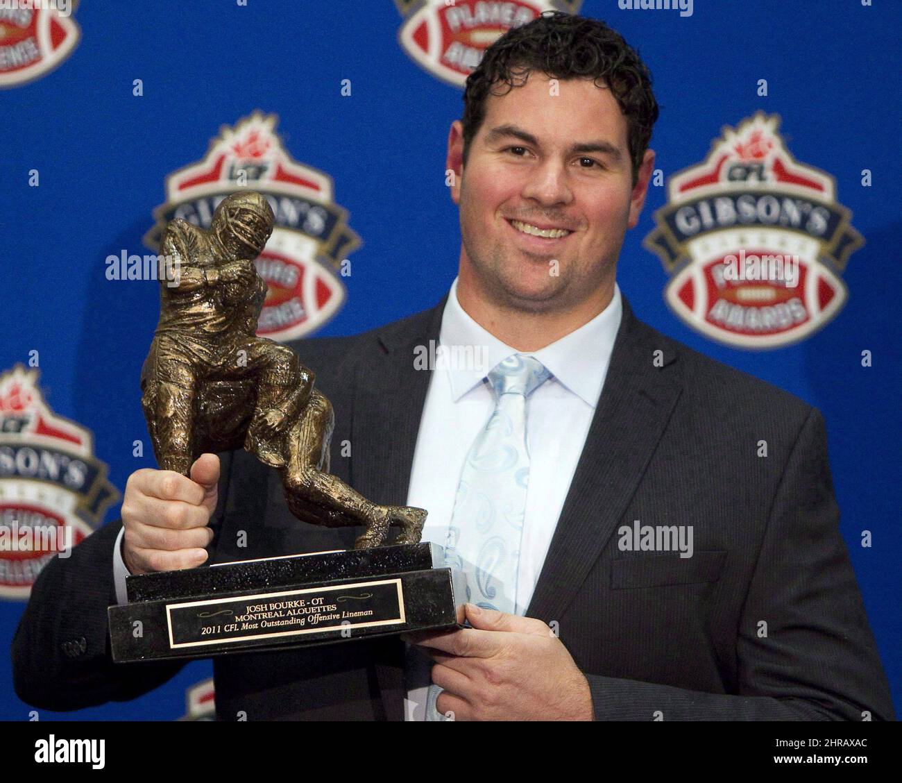 Montreal Alouettes' offensive tackle Josh Bourke holds his award for ...