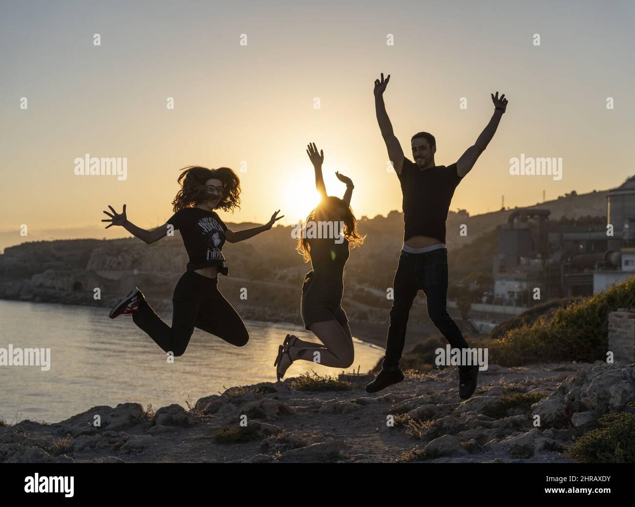 Young people jumping on the beach Stock Photo - Alamy