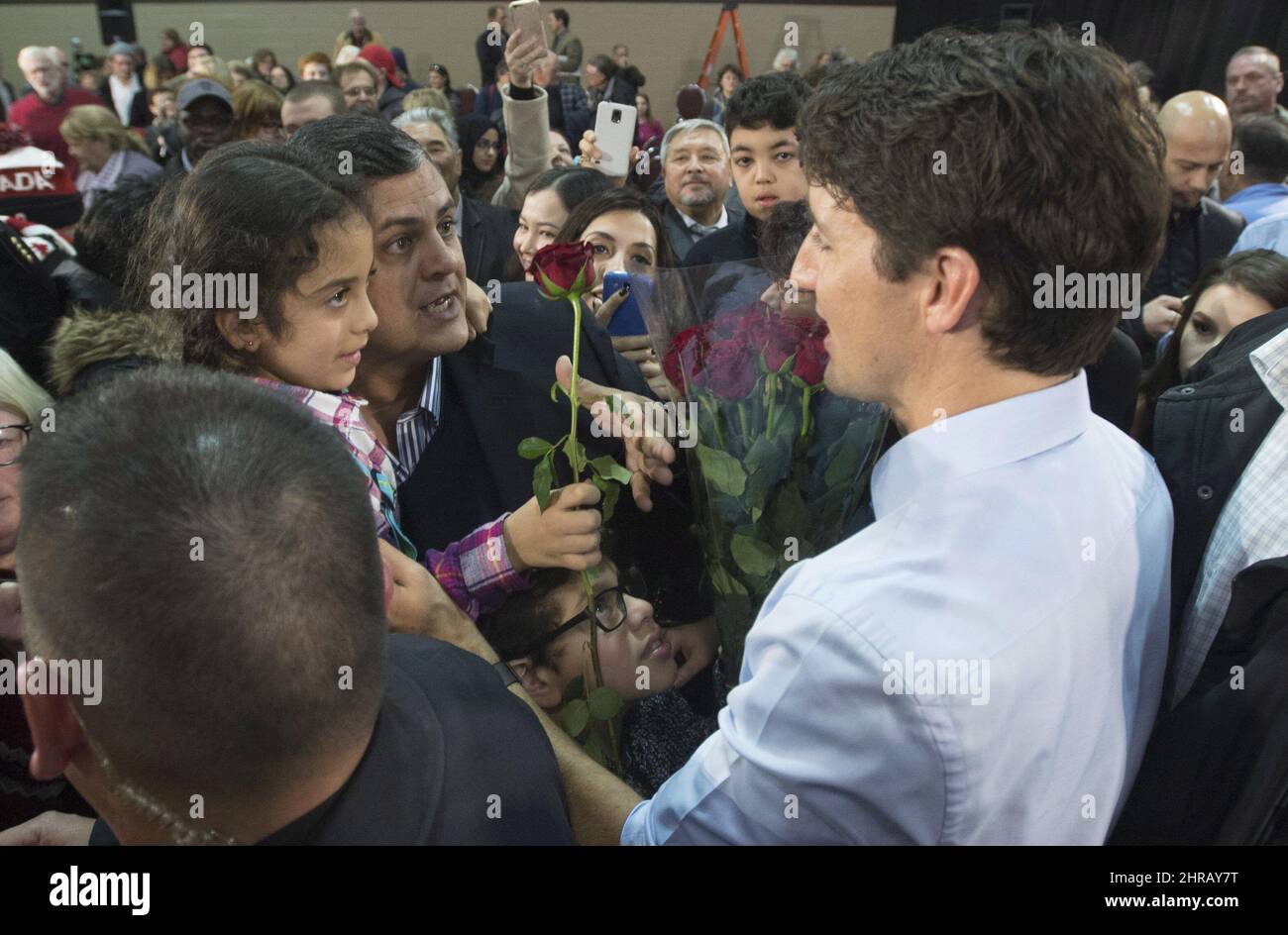 Wall Hashem and his daughter Hana present Prime Minister Justin Trudeau with roses following a ...