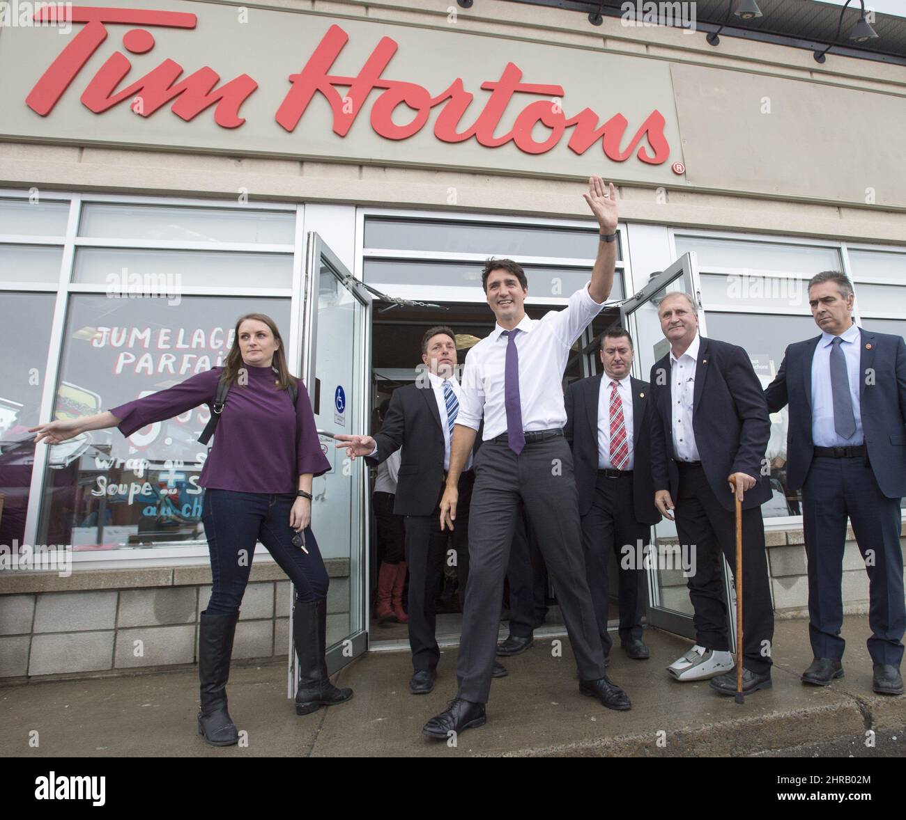 Prime Minister Justin Trudeau waves as he leaves a Tim Horton's after a ...