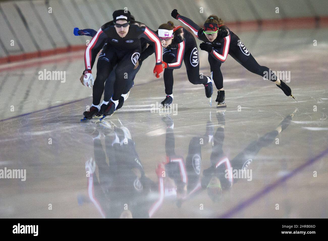 Long-track speedskater Marsha Hudey (R) skates with her teammates at ...
