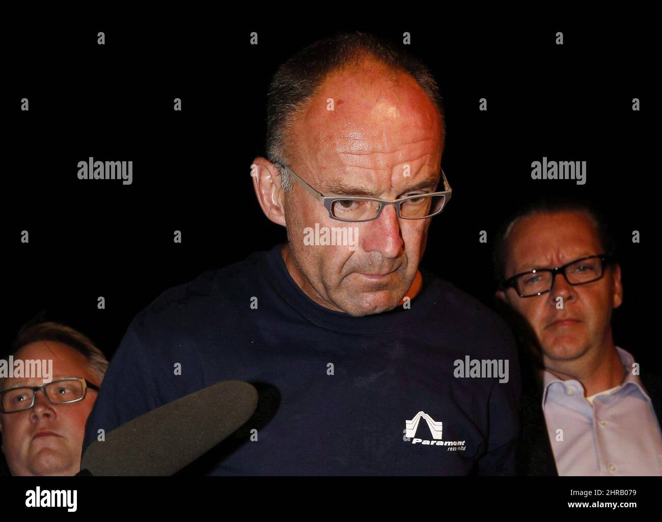Douglas Garland is escorted into a Calgary police station in connection ...