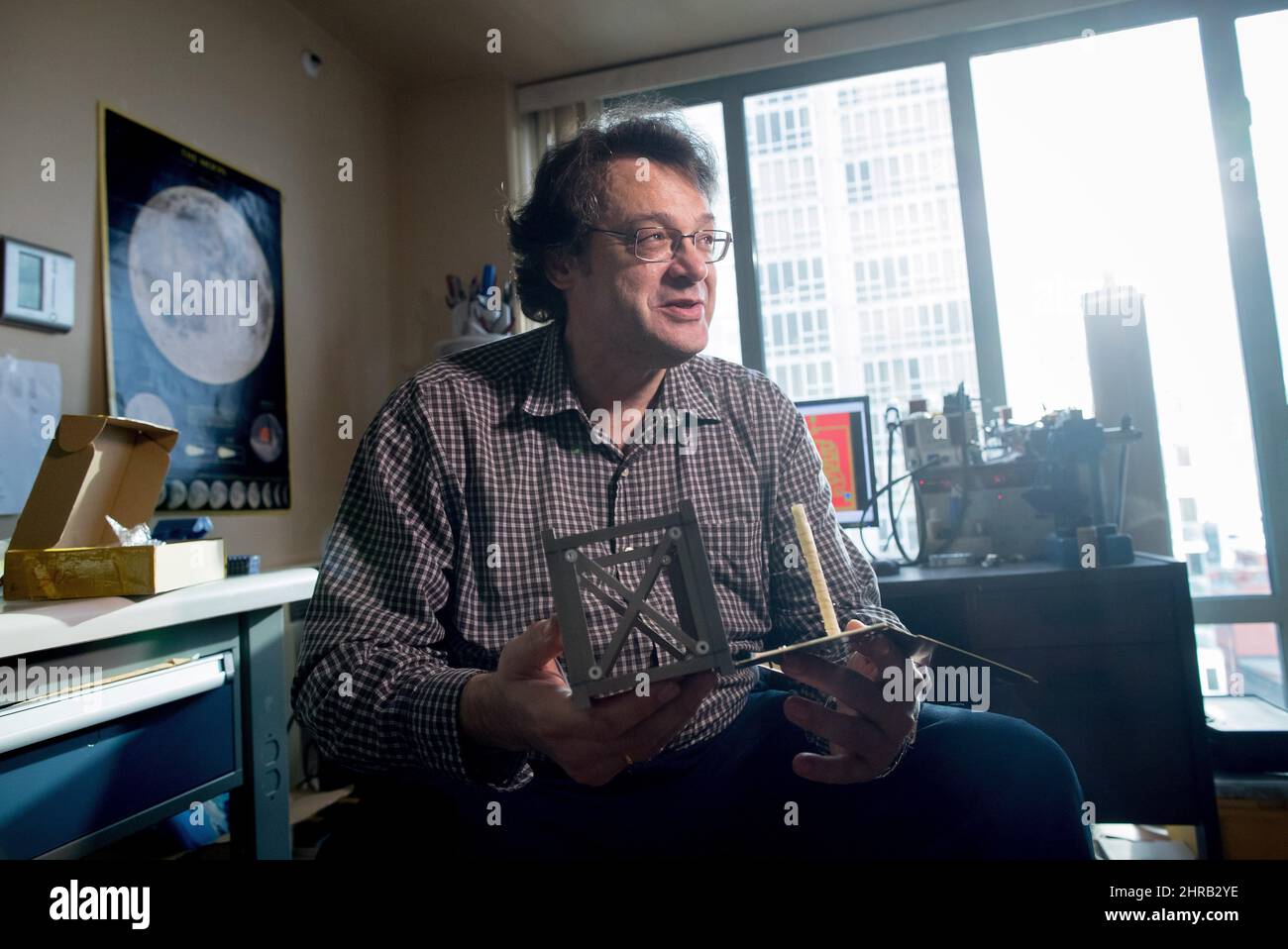 Alex Dobrianski, left, holds a model of the structure of his team's ...