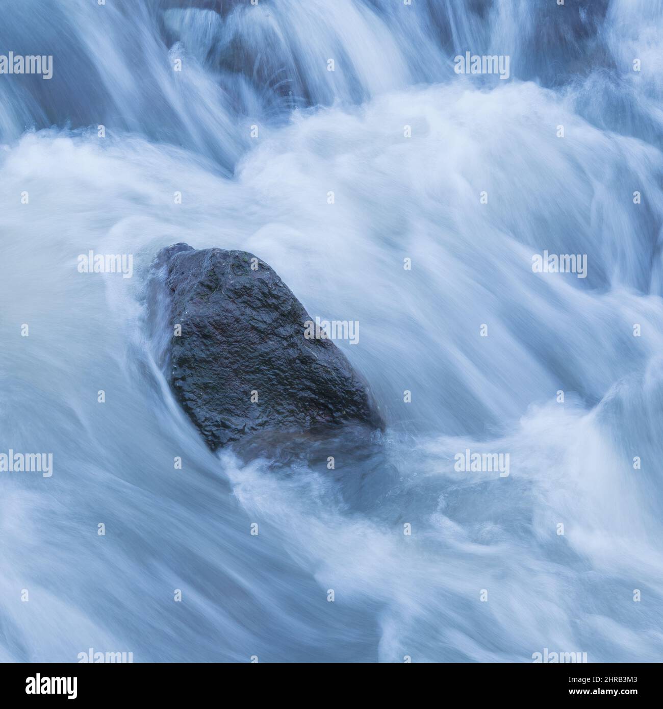 A silky effect of fast water stream splashing down the rocks Stock ...