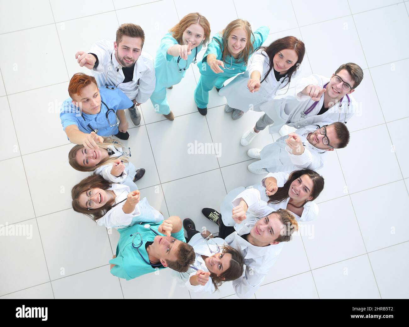top view. a group of smiling doctors pointing at you Stock Photo - Alamy