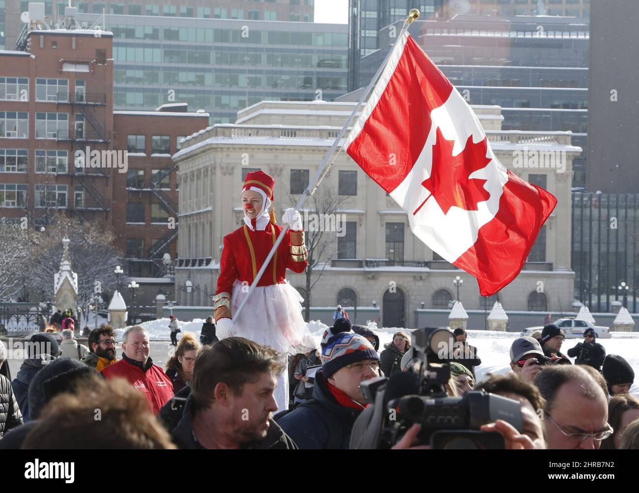 A clown on stilts waves the Canadian flag at a Flag Day celebration on ...