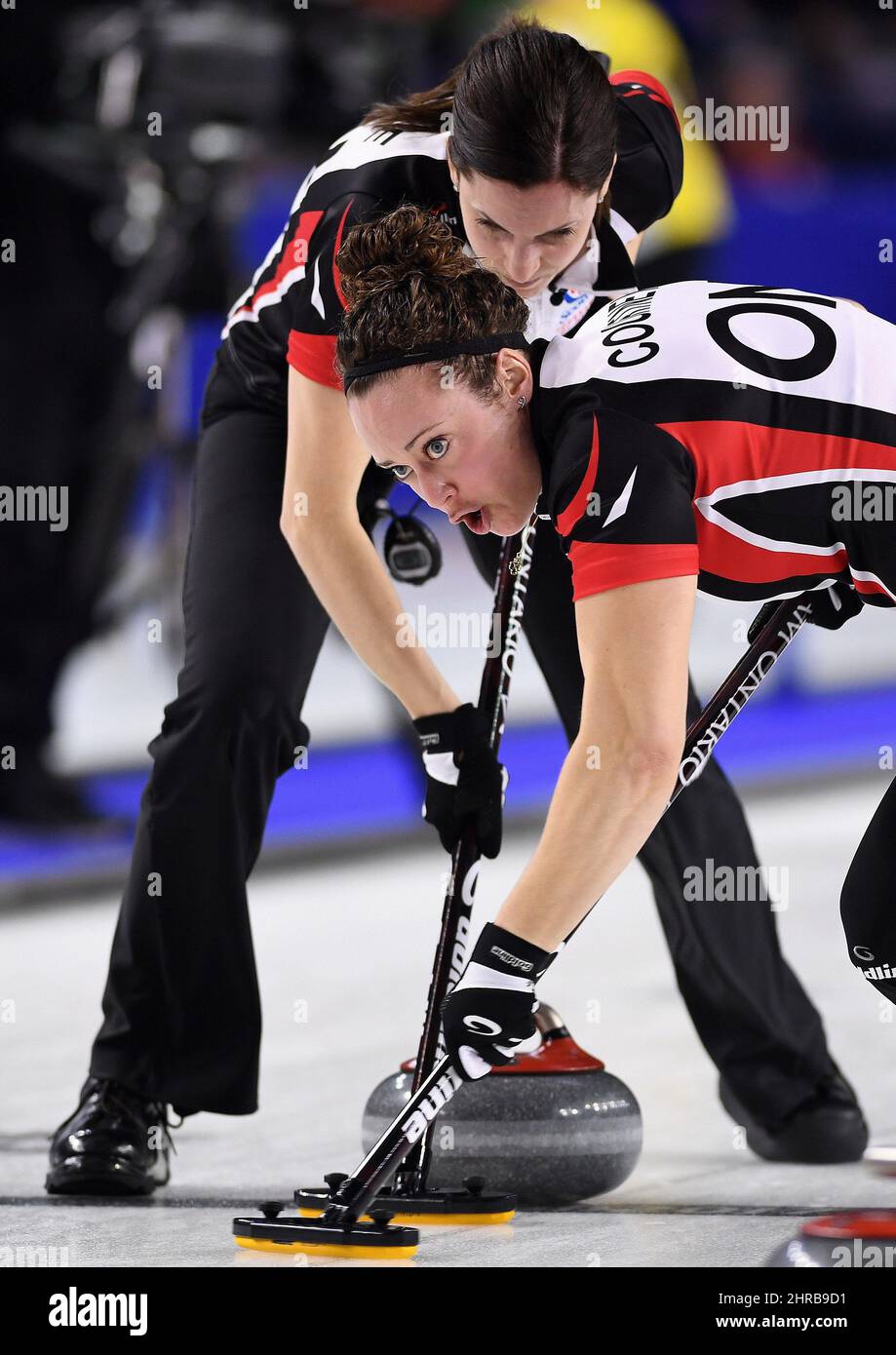 Ontario second Joanne Courtney (right)sweeps with lead Lisa Weagle as ...
