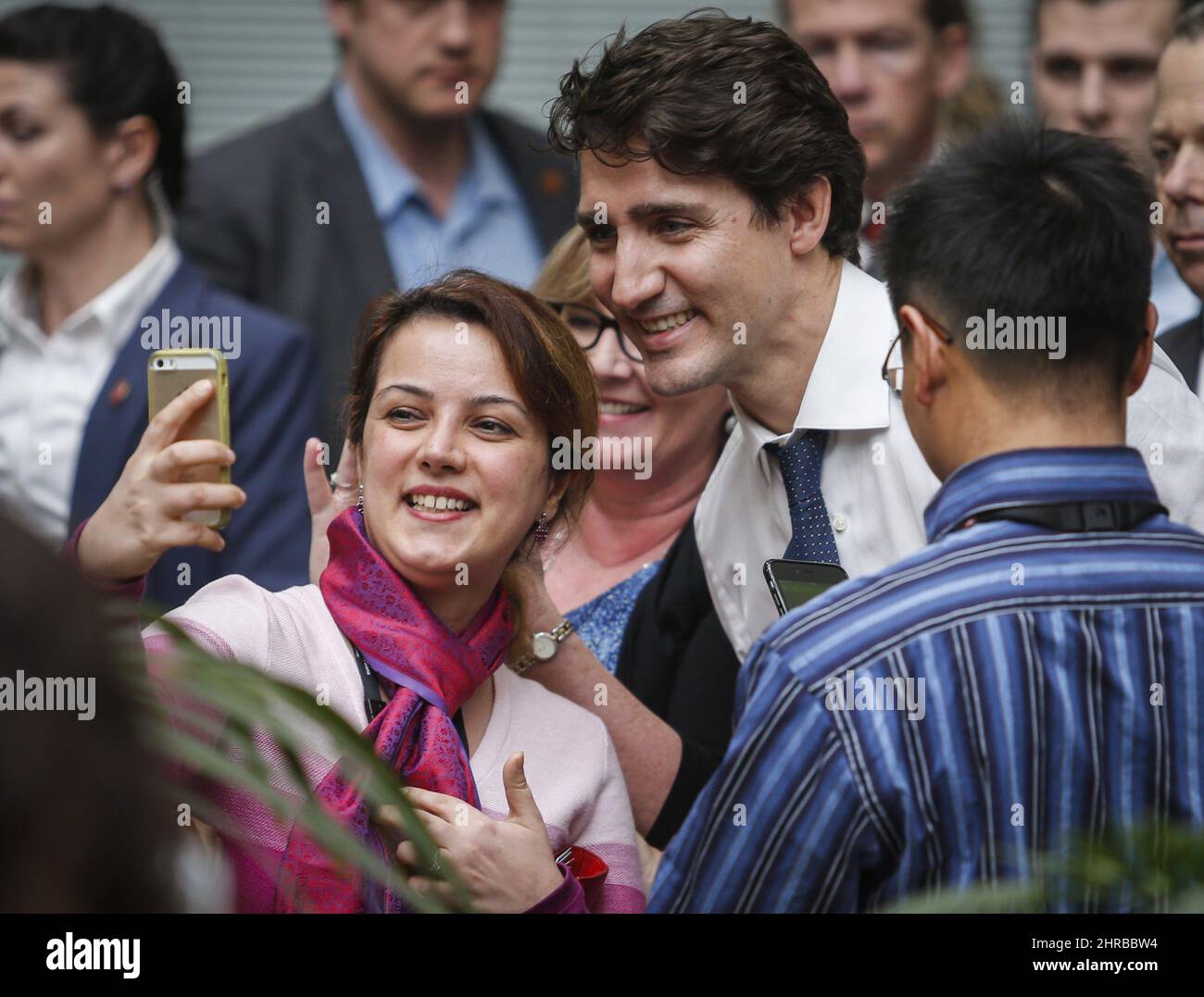 Prime Minister Justin Trudeau, centre, poses for selfies as he leaves a ...