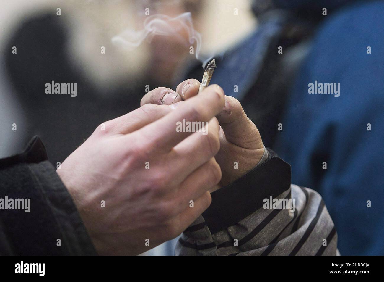Two men pass a marijuana joint at Cannabis Culture in Montreal in a ...