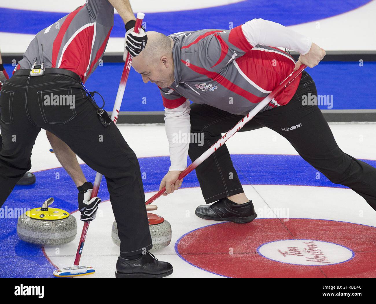 Northwest Territories skip Jamie Koe sweeps a rock in the house as they ...