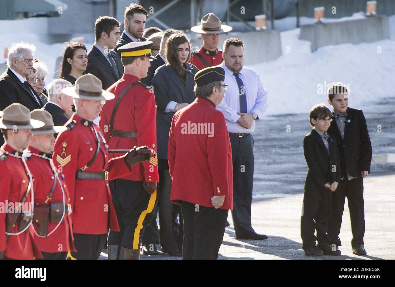 Family members of RCMP Constable Richer Dubuc look on following his ...