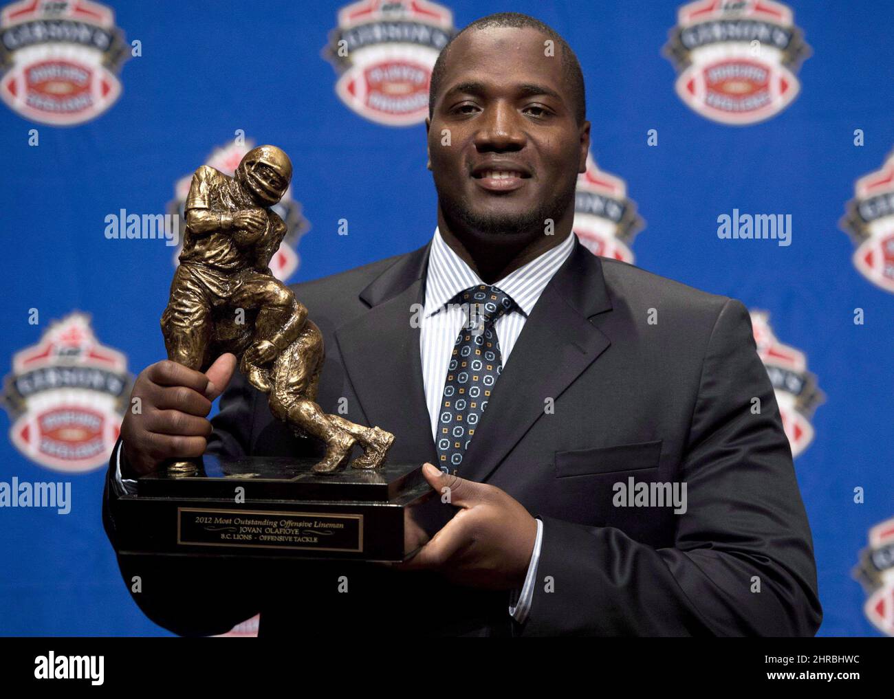 B.C. Lions offensive tackle Jovan Olafioye holds the trophy for Most ...