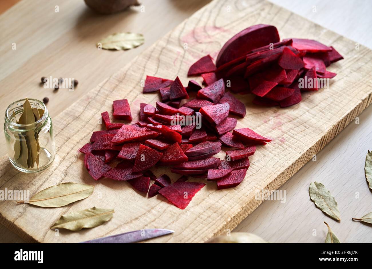 Cut up red beetroot with spices on a table - preparation of fermented ...