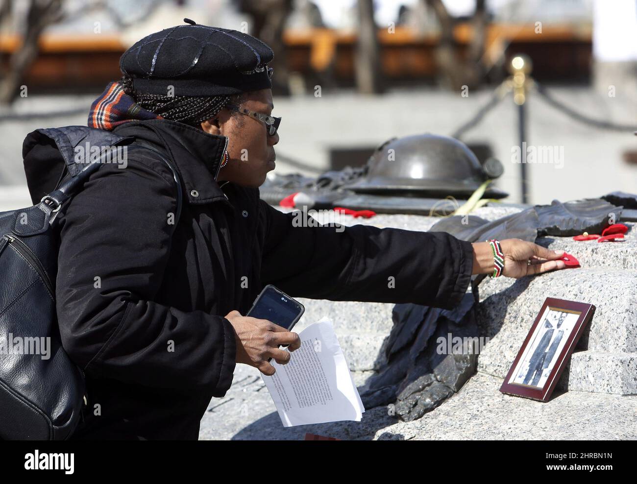 Sarah Onyango of Ottawa lays a poppy on the Tomb of the Unknown Soldier ...