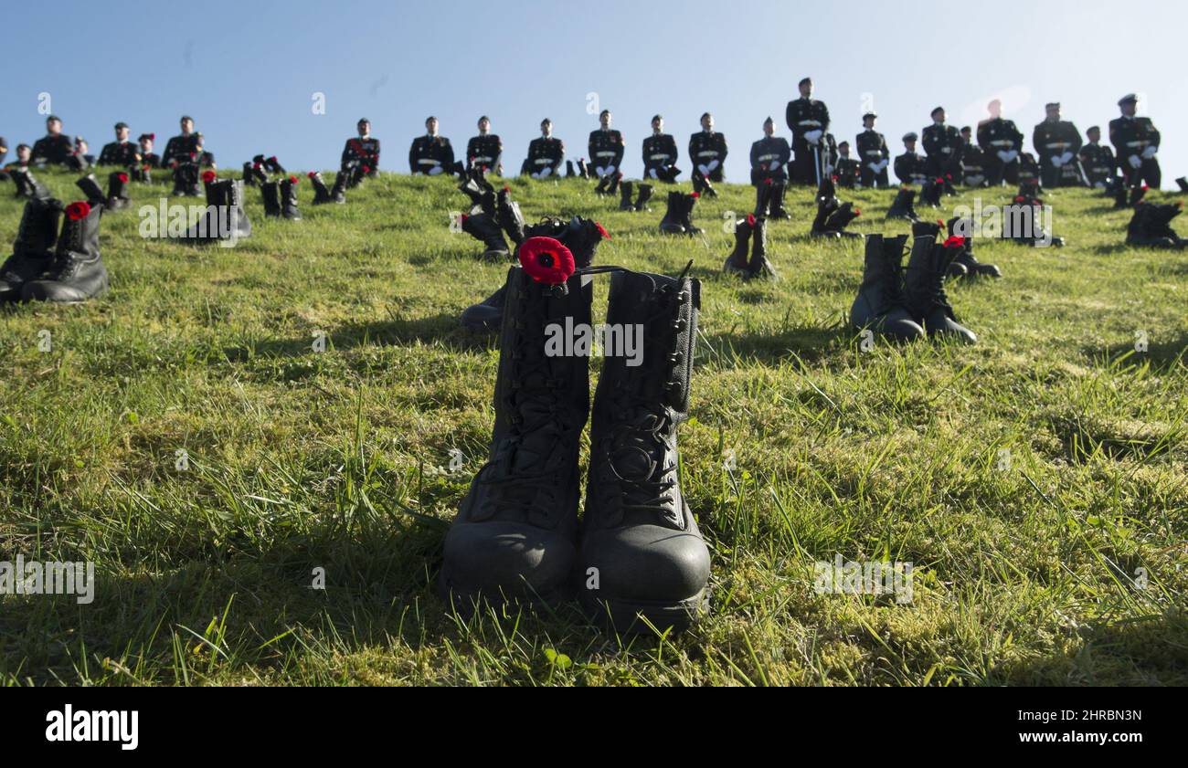 Canadian Forces soldiers parade at Vimy Ridge behind boots placed to ...