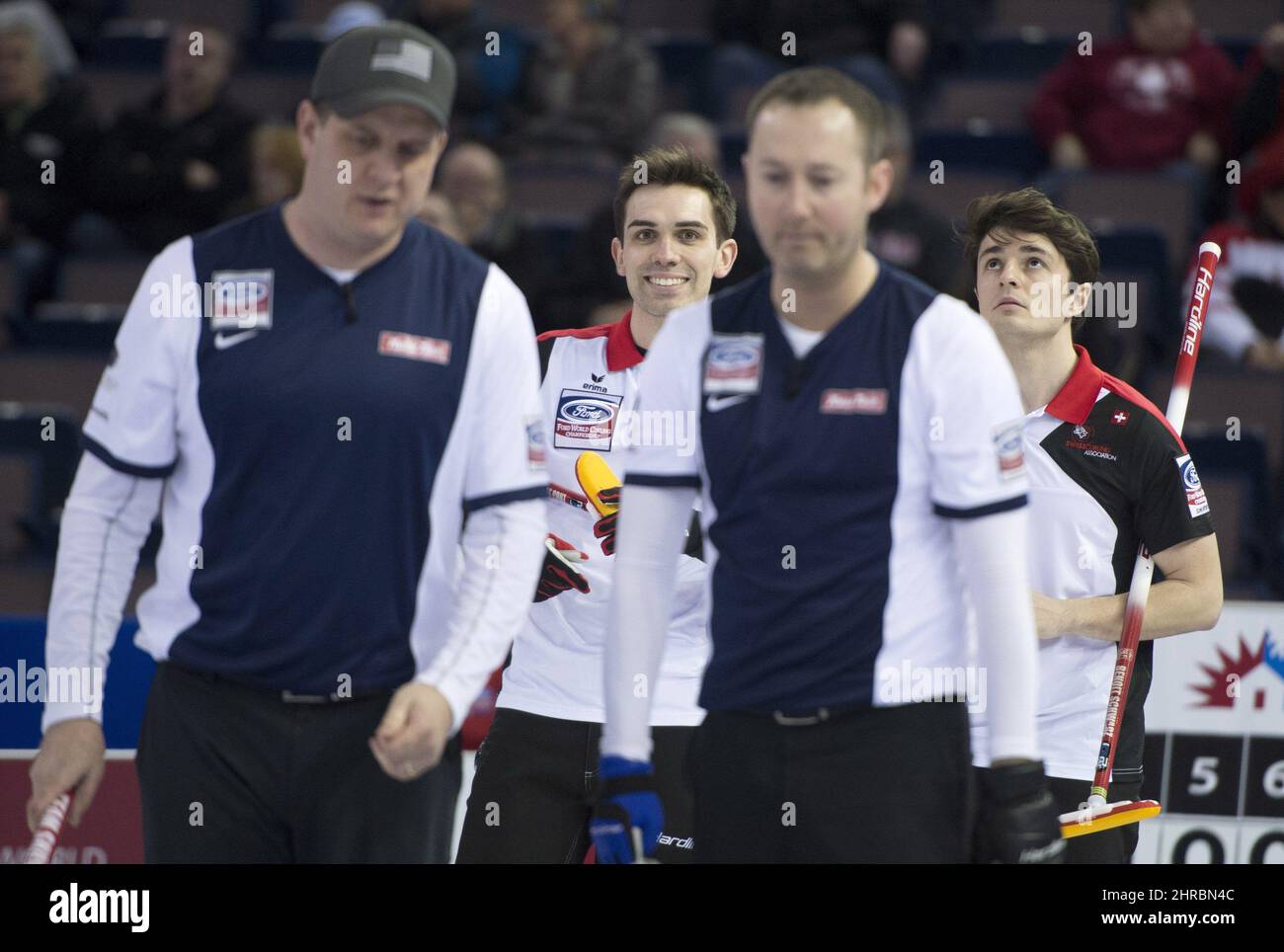 Switzerland skip Peter de Cruz, centre, smiles as he and fourth Benoit ...