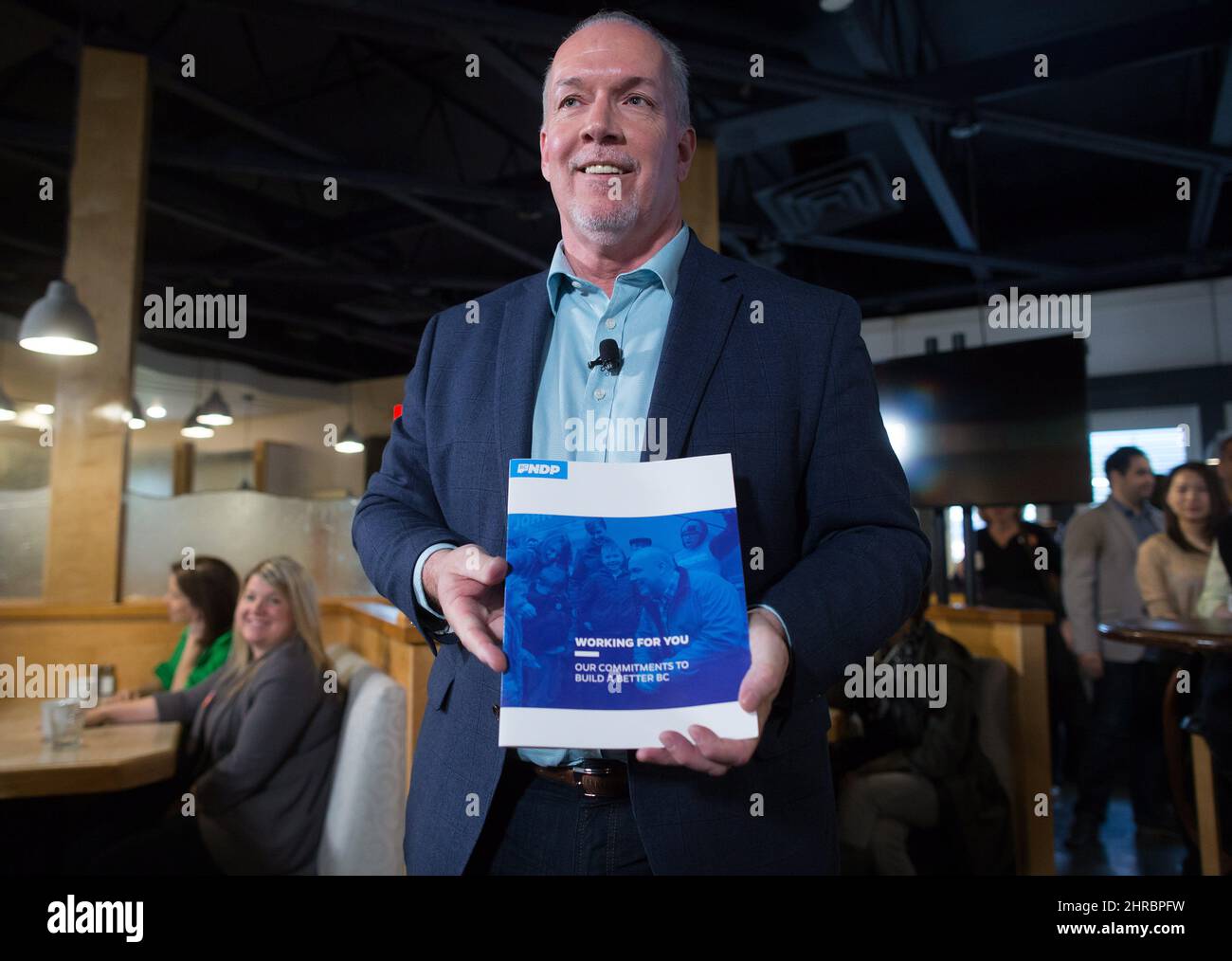 NDP Leader John Horgan holds a copy of the party's election platform ...