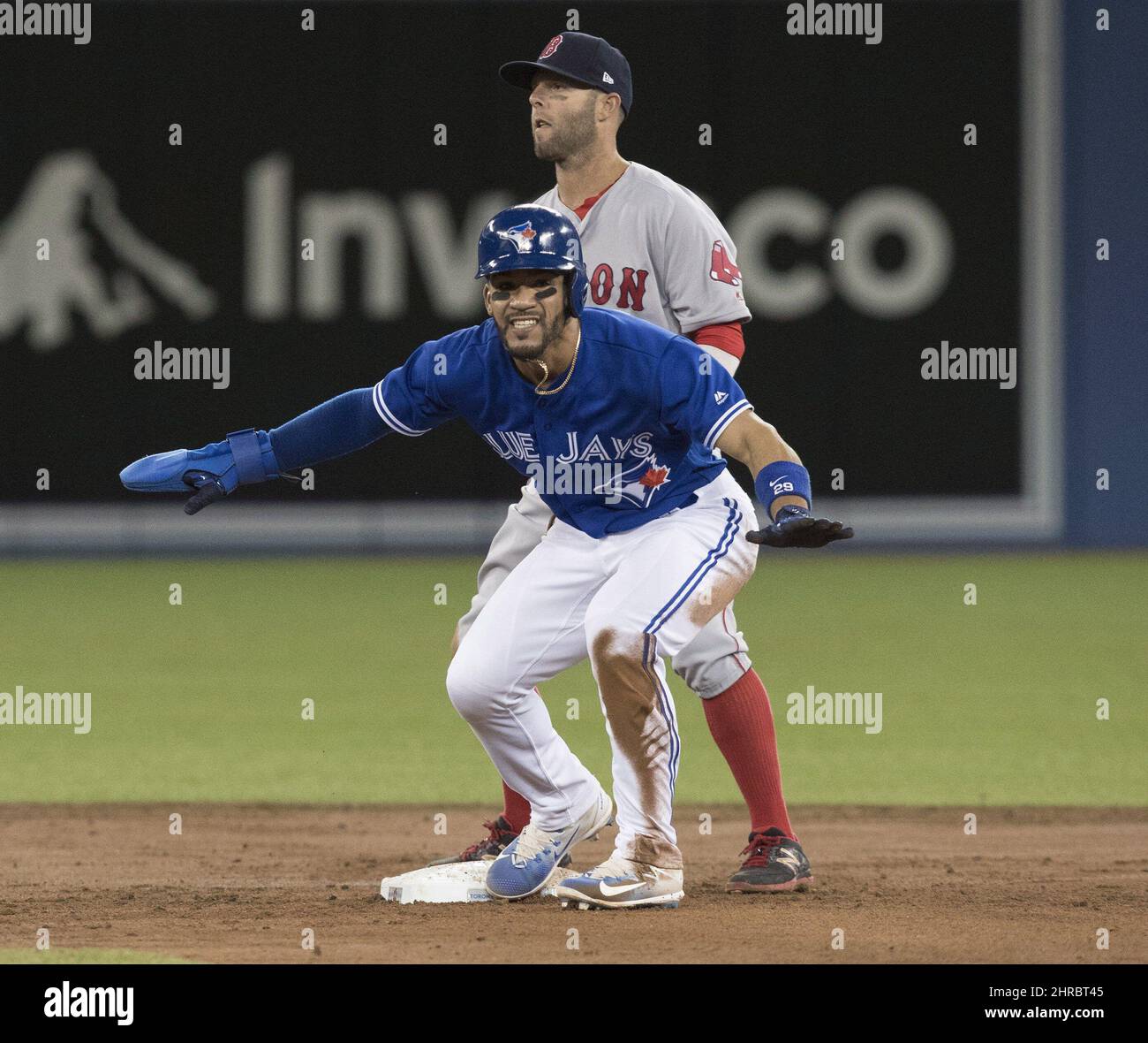 Toronto Blue Jays Devon Travis, front, slides in safe at second base as ...