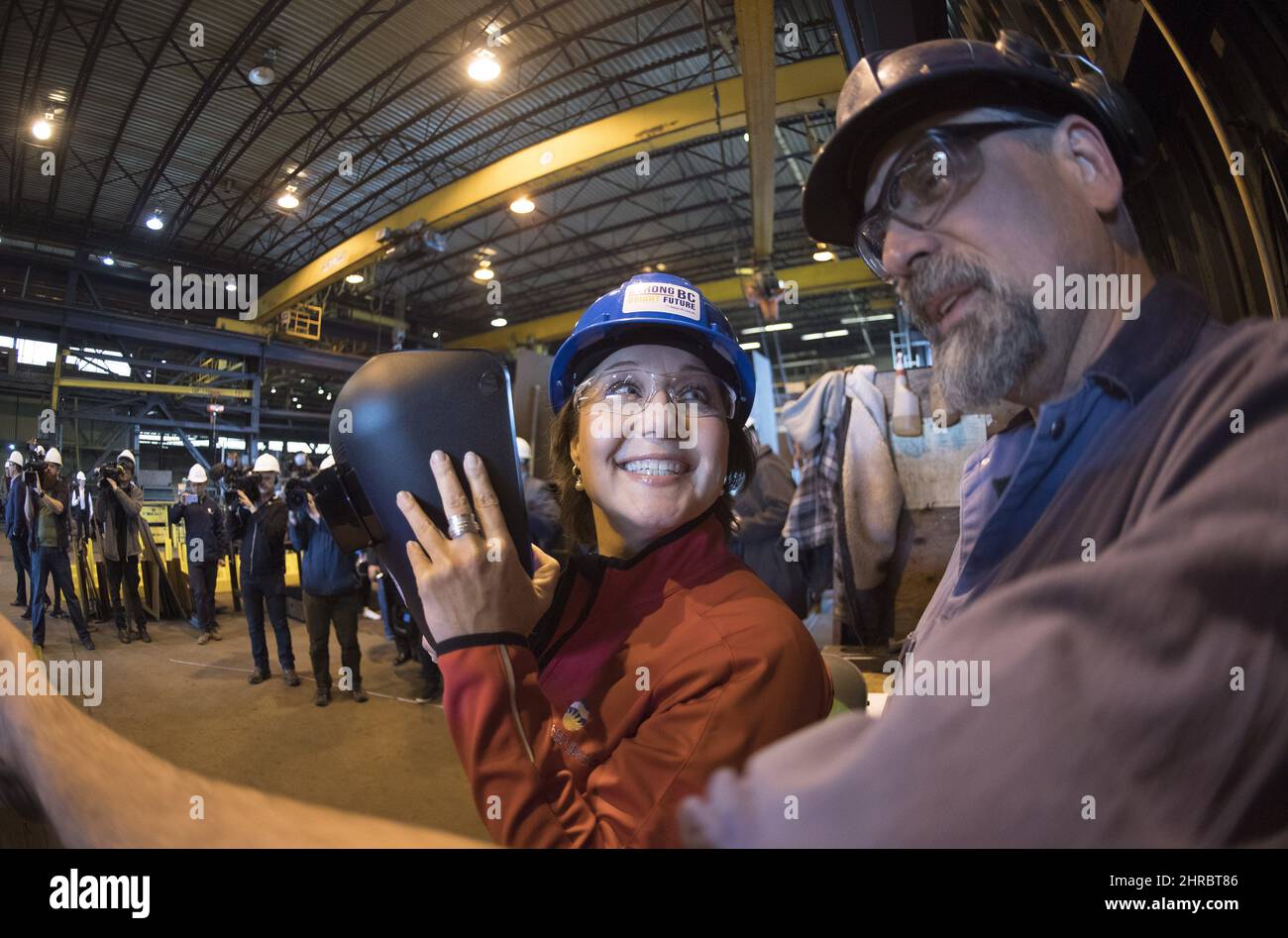 BC Liberal Leader Christy Clark uses a welding mask to shield herself ...