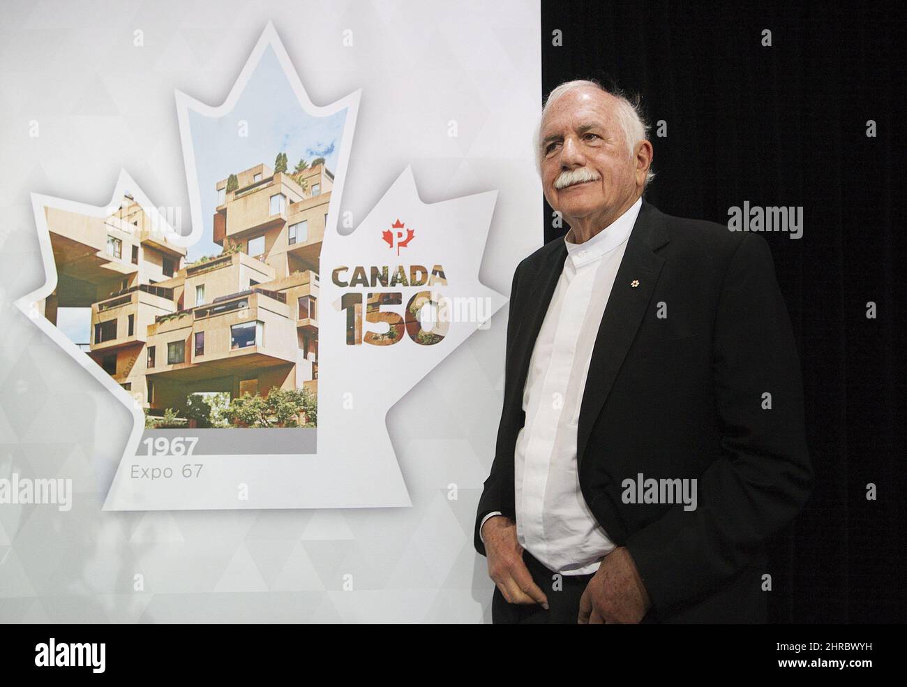 Architect Moshe Safdie looks at a new Canada Post stamp depicting his ...