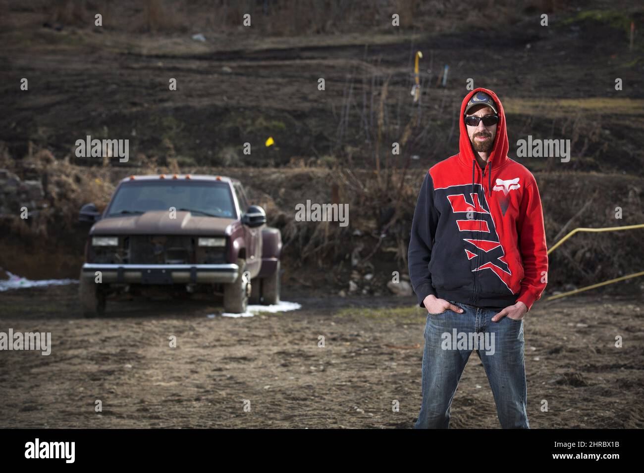 Shane Ganong stands where his house and workshop burned down during the ...