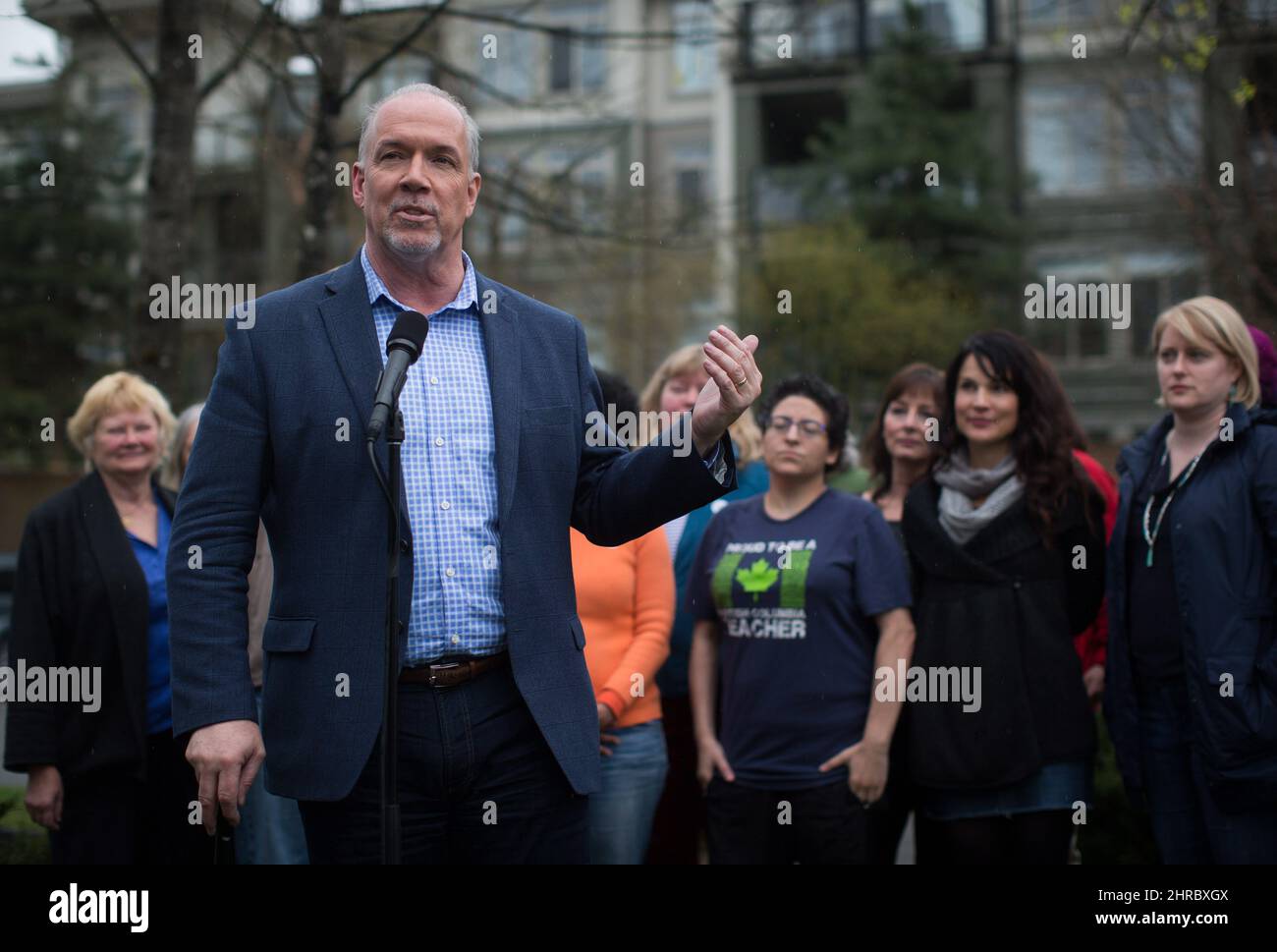 NDP Leader John Horgan is flanked by teachers as he speaks during a ...