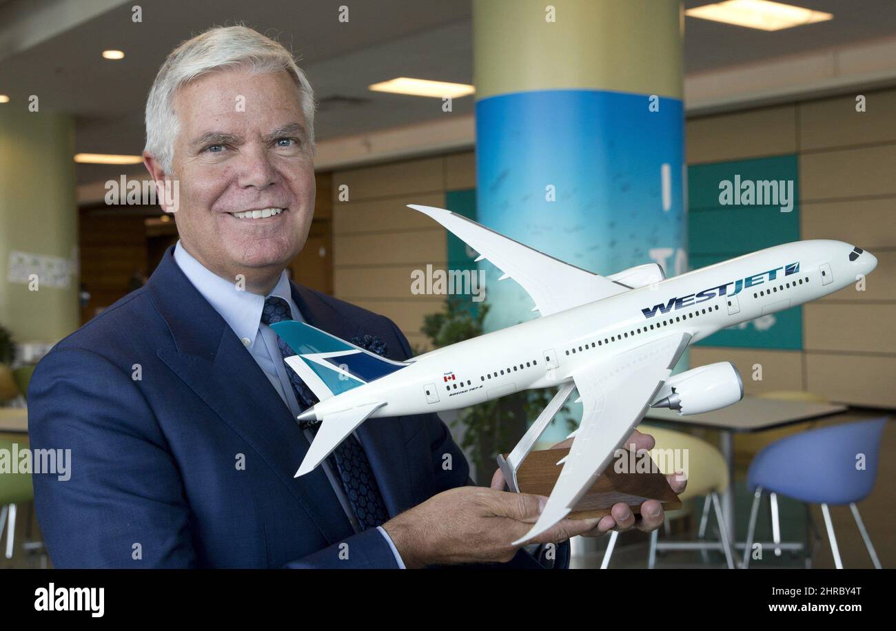 WestJet Airlines President & CEO Gregg Saretsky holds a model of the ...