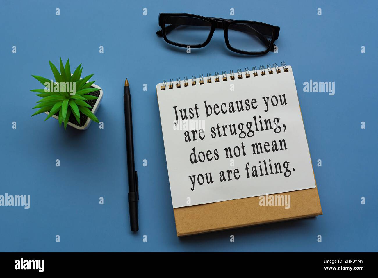 Motivational and inspirational quote on notepad with potted plant ...