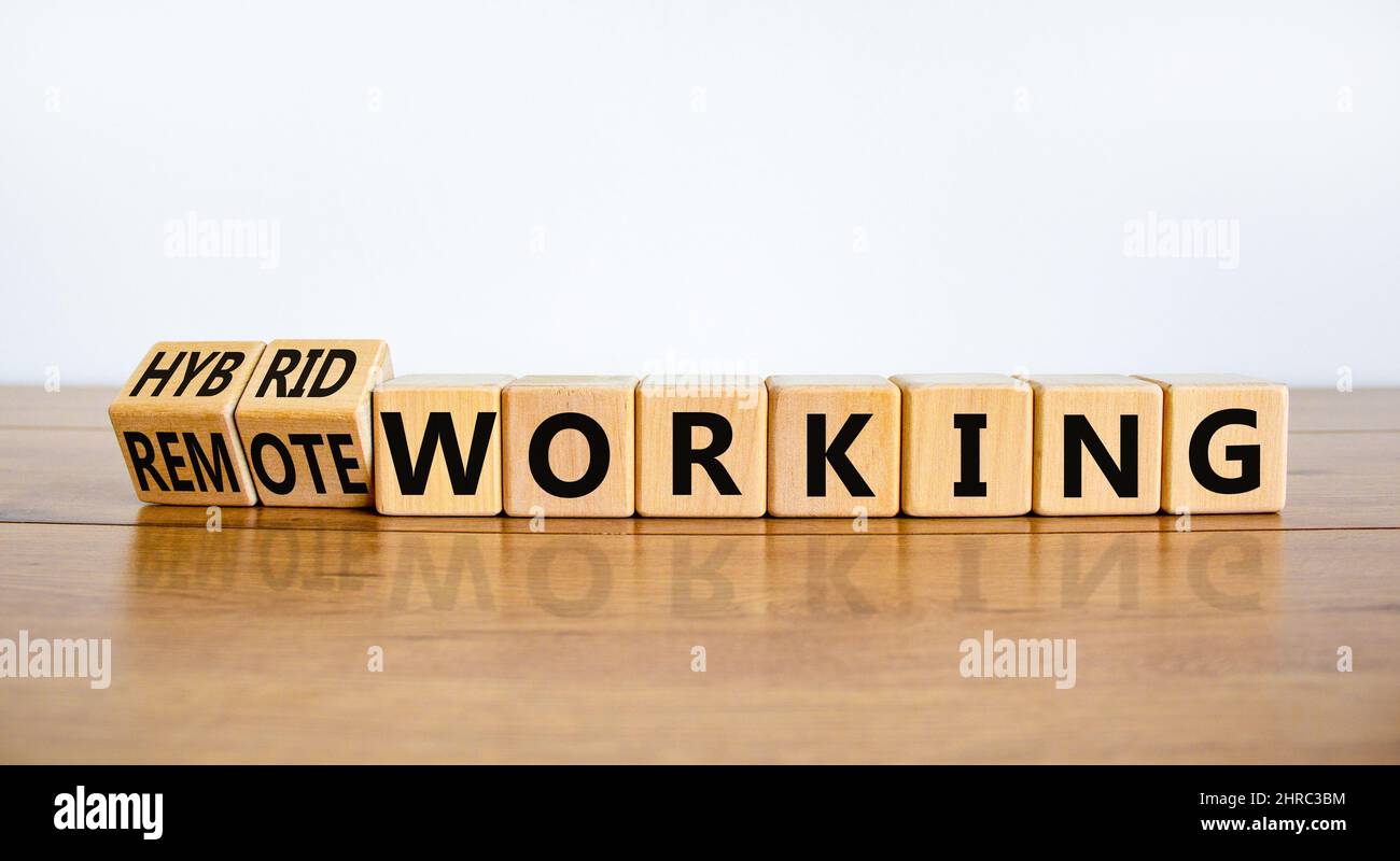 Hybrid or remote working symbol. Turned wooden cubes and changed words ...
