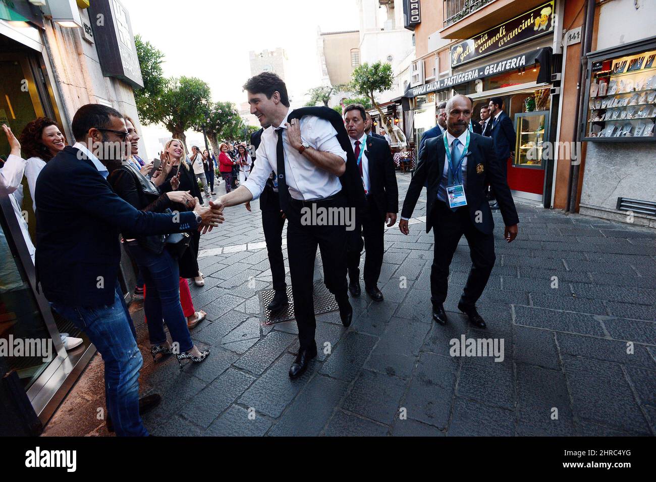 Prime Minister Justin Trudeau shakes hands as he walks through the ...