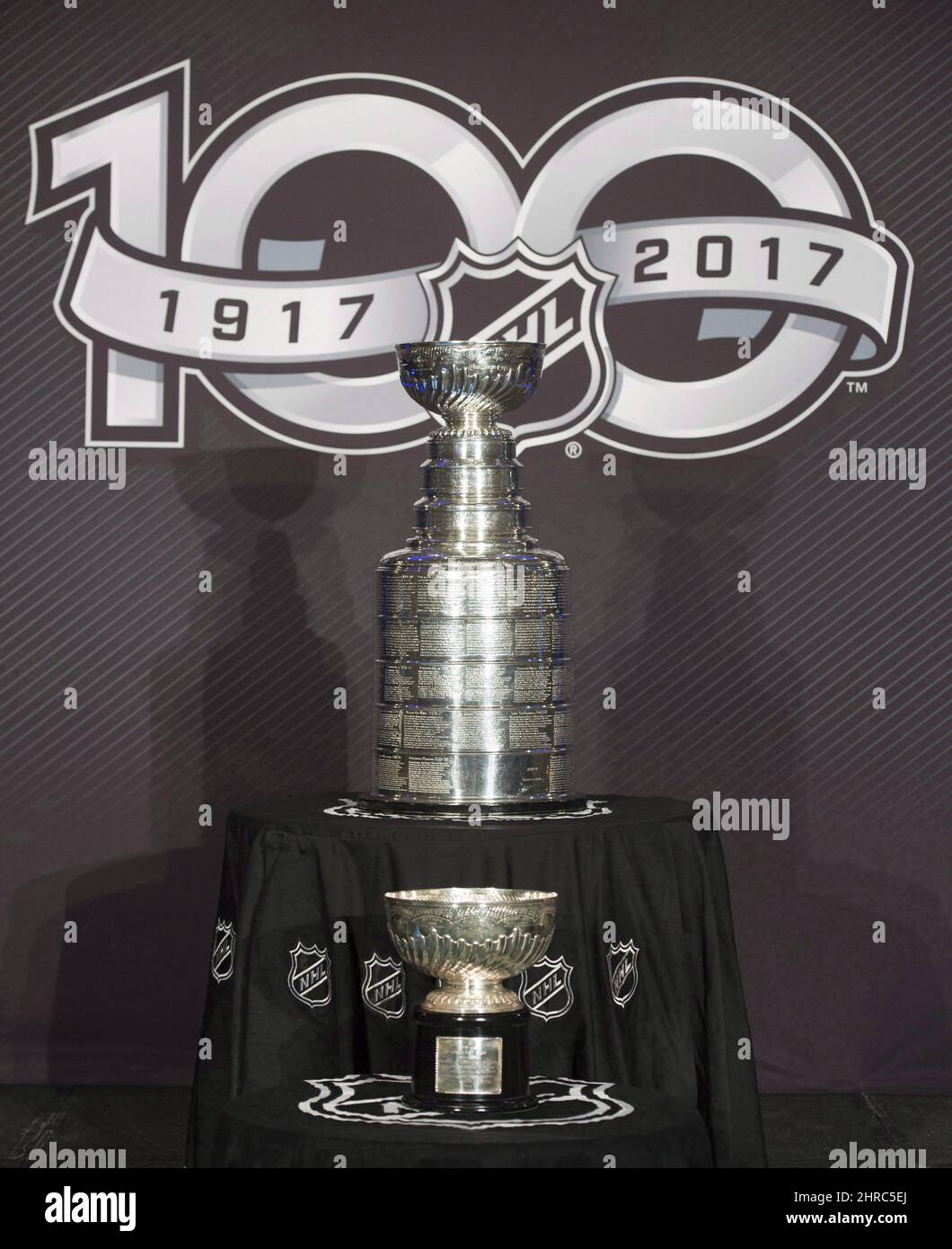 The Stanley Cup trophy and the original Stanley Cup are seen on display ...