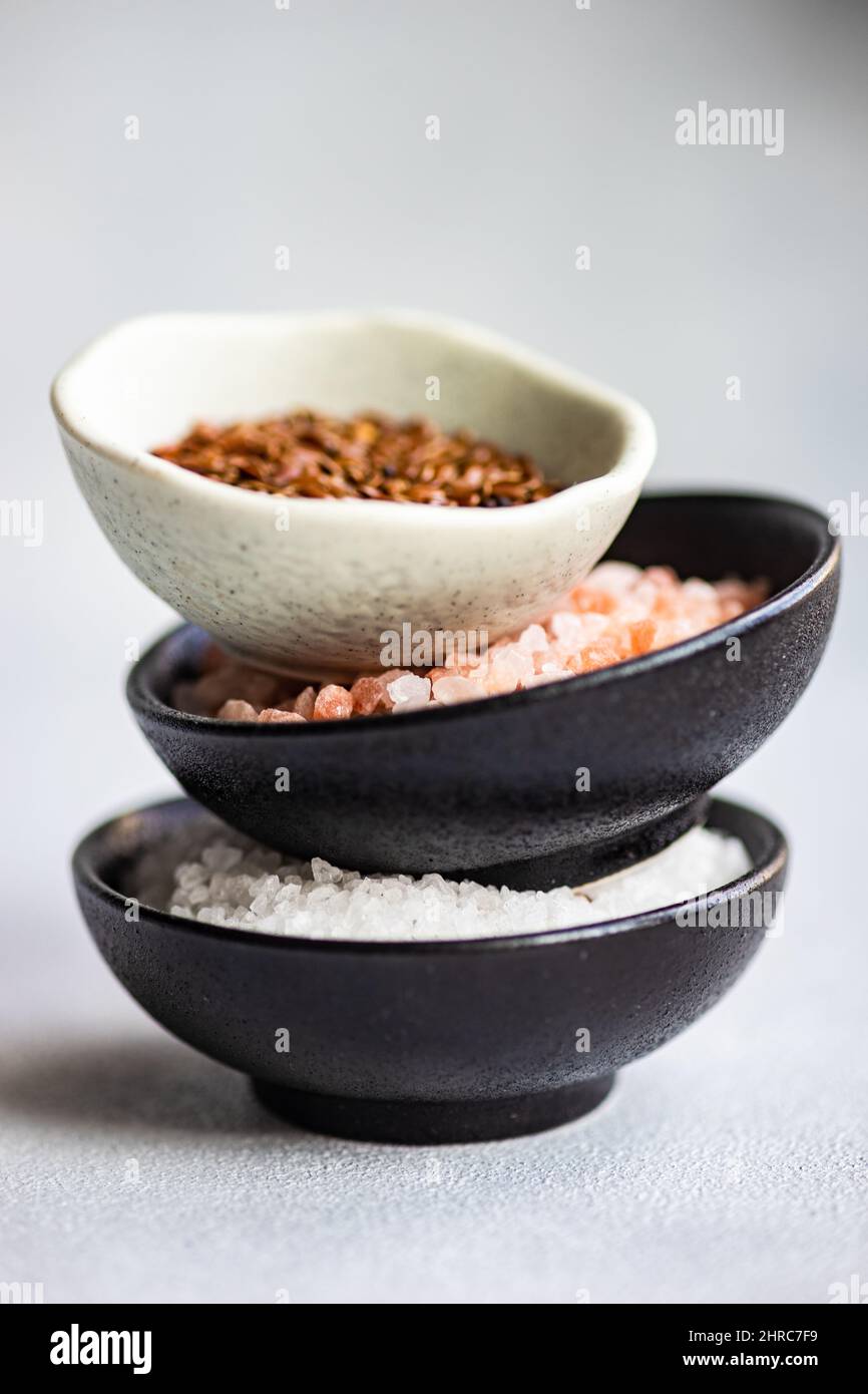 Stack of bowls filled with flax seeds, pink Himalayan salt and rock ...