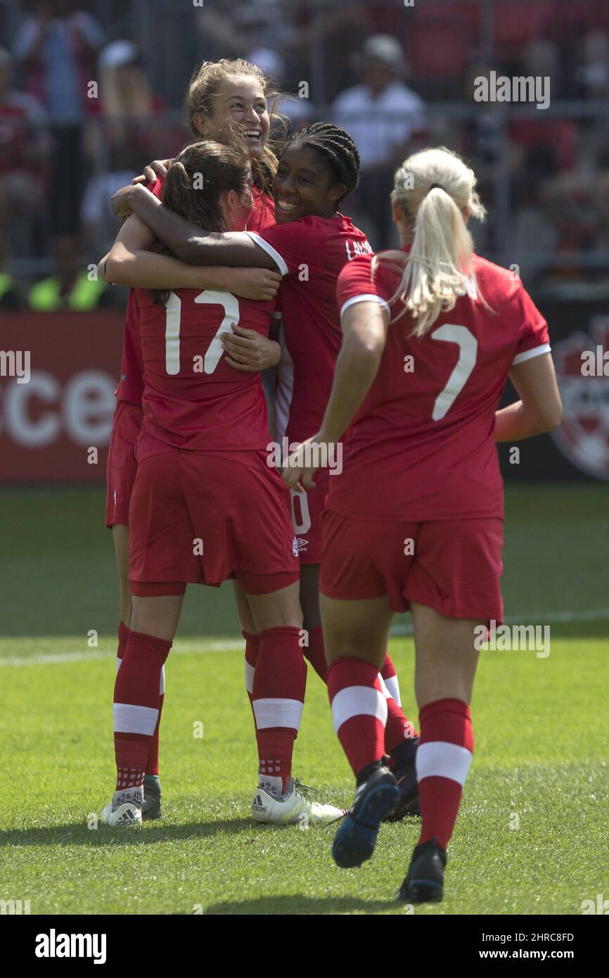 Canada's Jordyn Huitema (centre left) celebrates with Ashley Lawrence ...