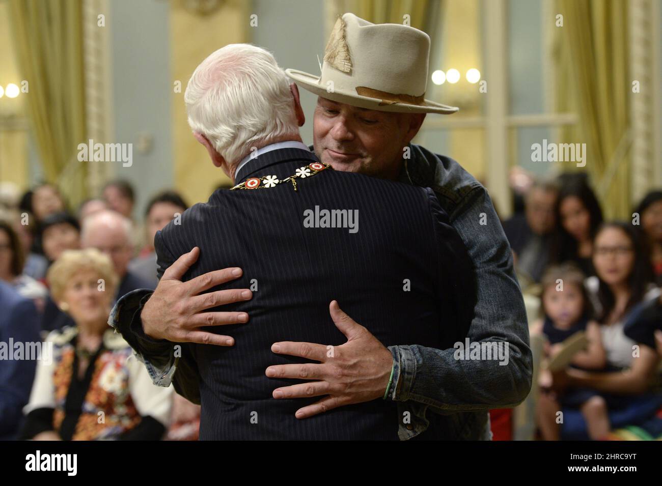 Tragically Hip singer Gord Downie hugs Governor General David Johnston after receiving the Order ...
