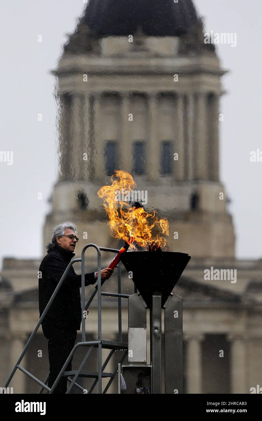 Elder Dave Courchene, carrying a sacred fire torch carried from Manitou ...