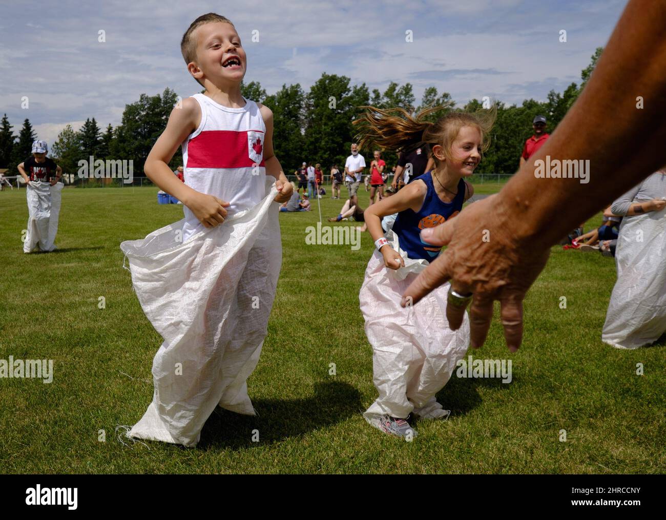 Kids 5-7 compete in a sack race during Canada Day celebrations in ...