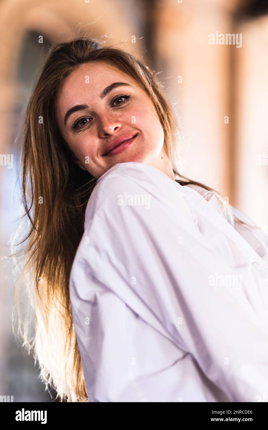Vertical portrait of nice and warm caucasian young woman looking over ...