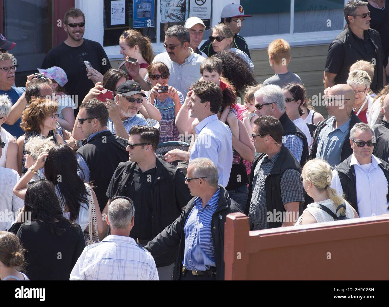 Prime Minister Justin Trudeau is surrounded by a crowd as he walks ...