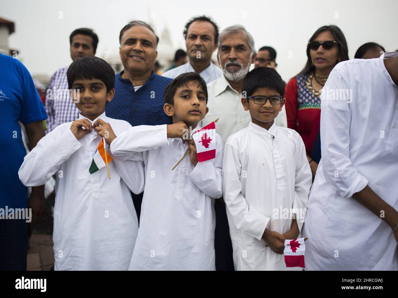Young boys hold flags as they await the arrival of Prime Minister ...