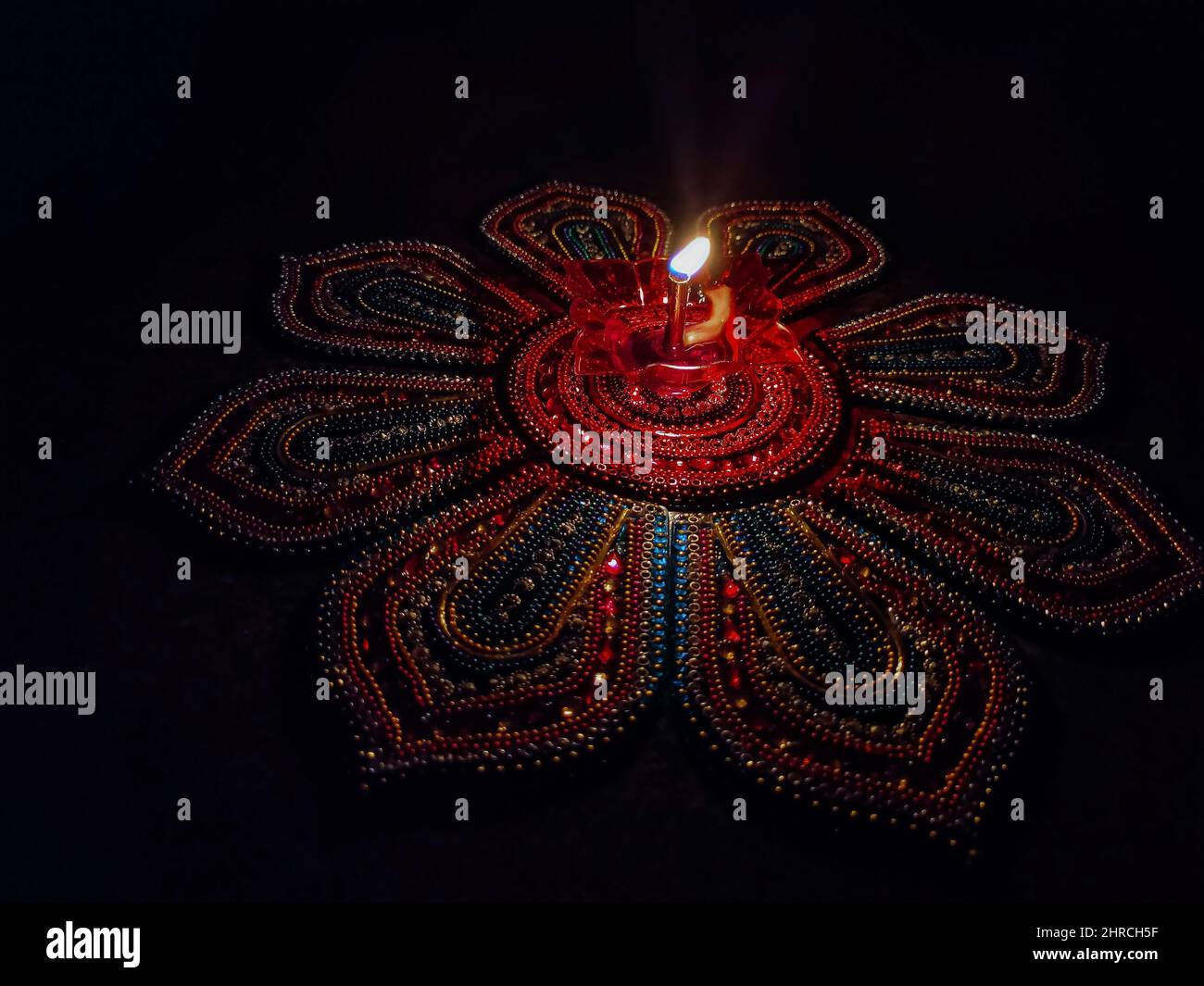 Burning red plastic oil lamp at a Diwali festival in Bangalore ...