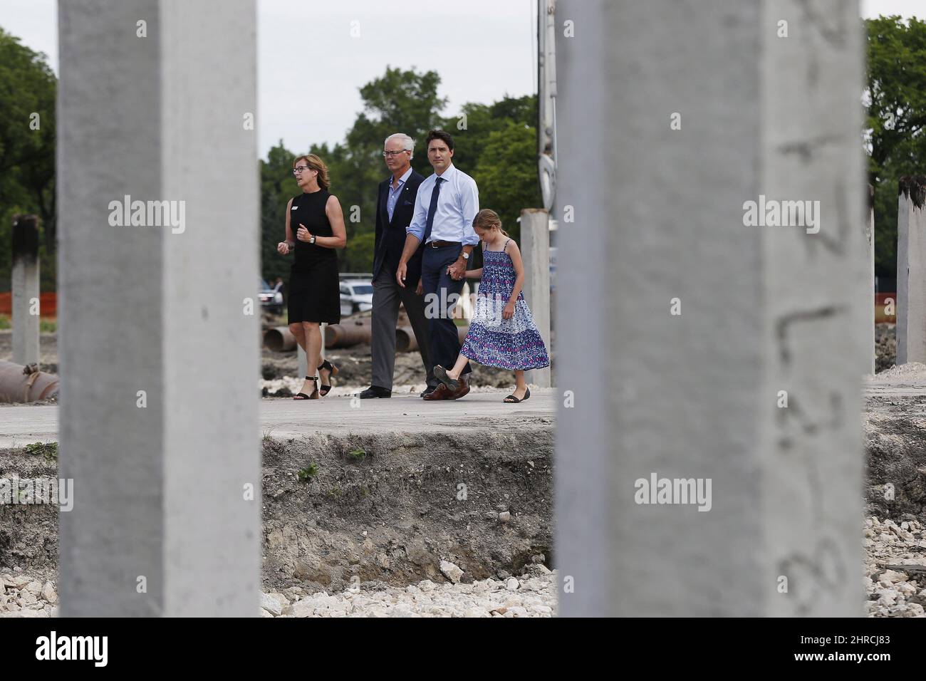 Prime Minister Justin Trudeau walks with Margaret Redman, left ...