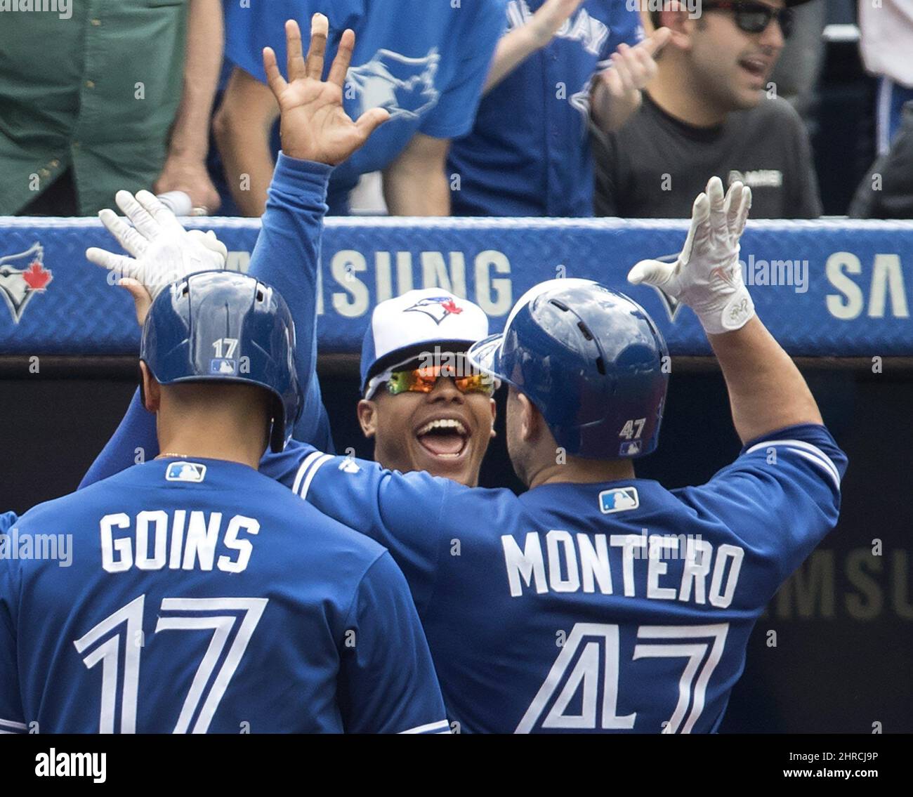 Toronto Blue Jays' Miguel Montero is met by team mates at the dugout ...