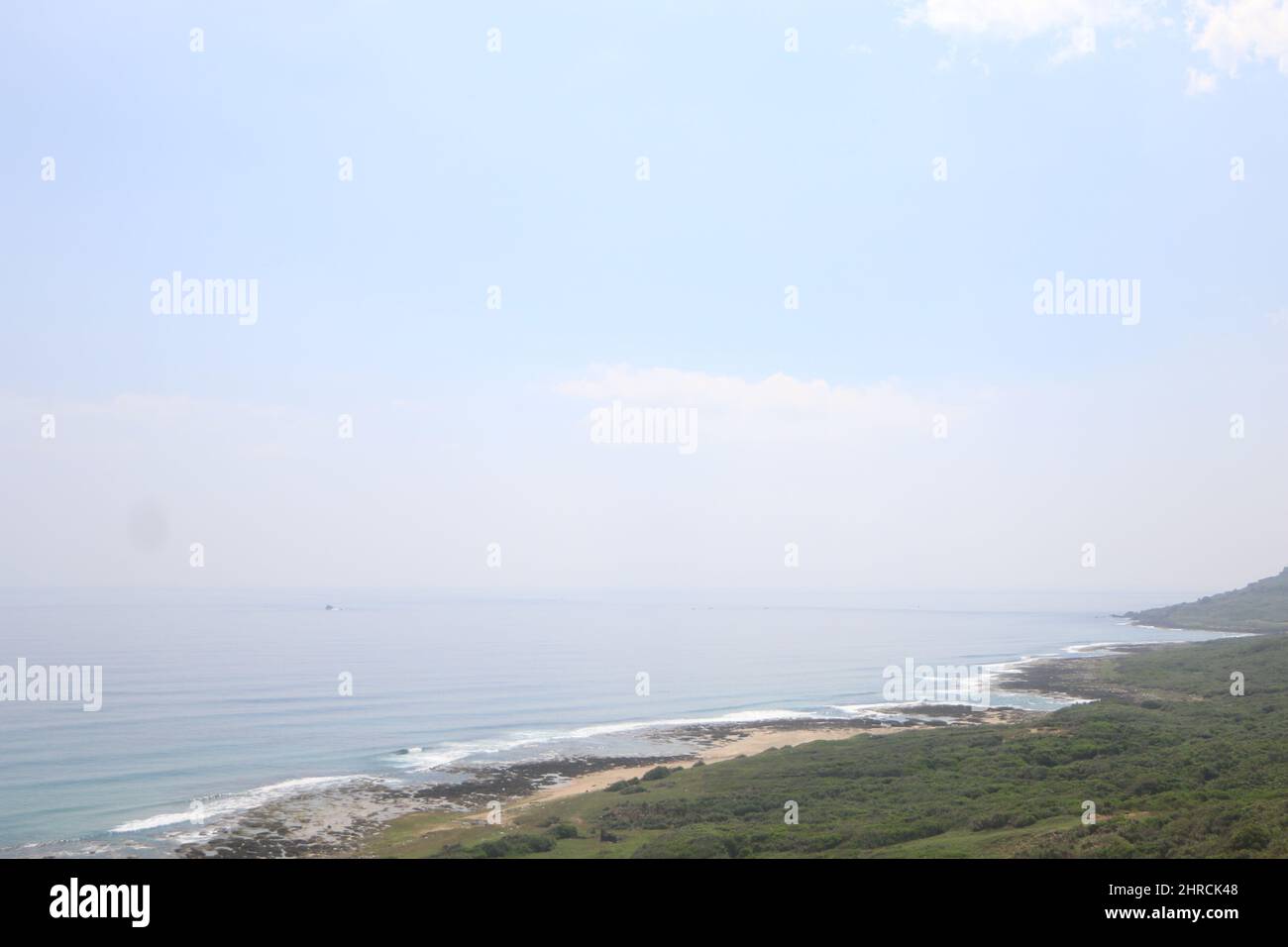 Aerial top view of the crystal clear water of the sea washing the shore ...