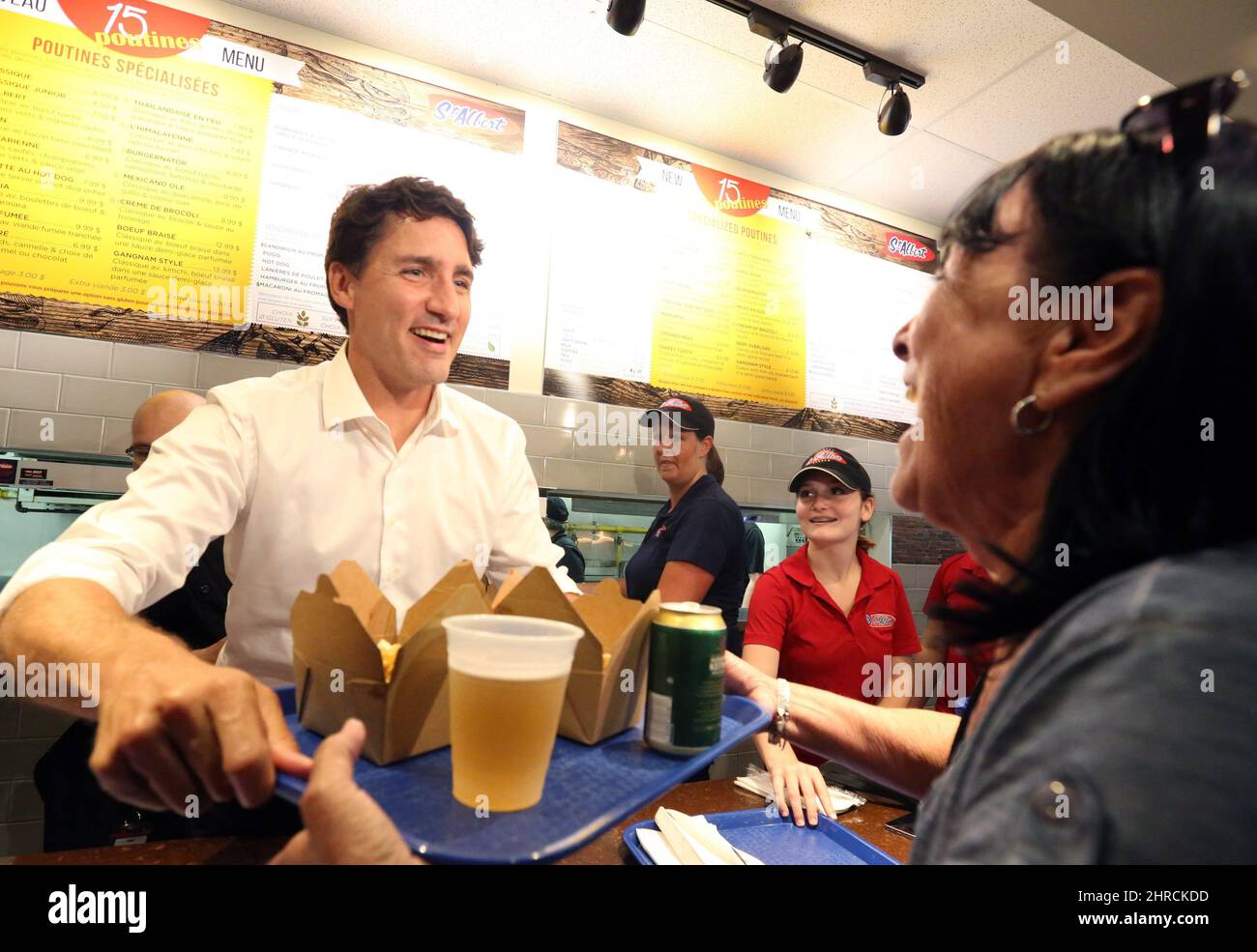 Prime Minister Justin Trudeau serves food as he visits the St-Albert ...