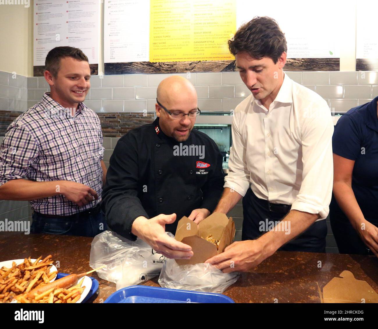 Prime Minister Justin Trudeau serves food as he visits the St-Albert ...