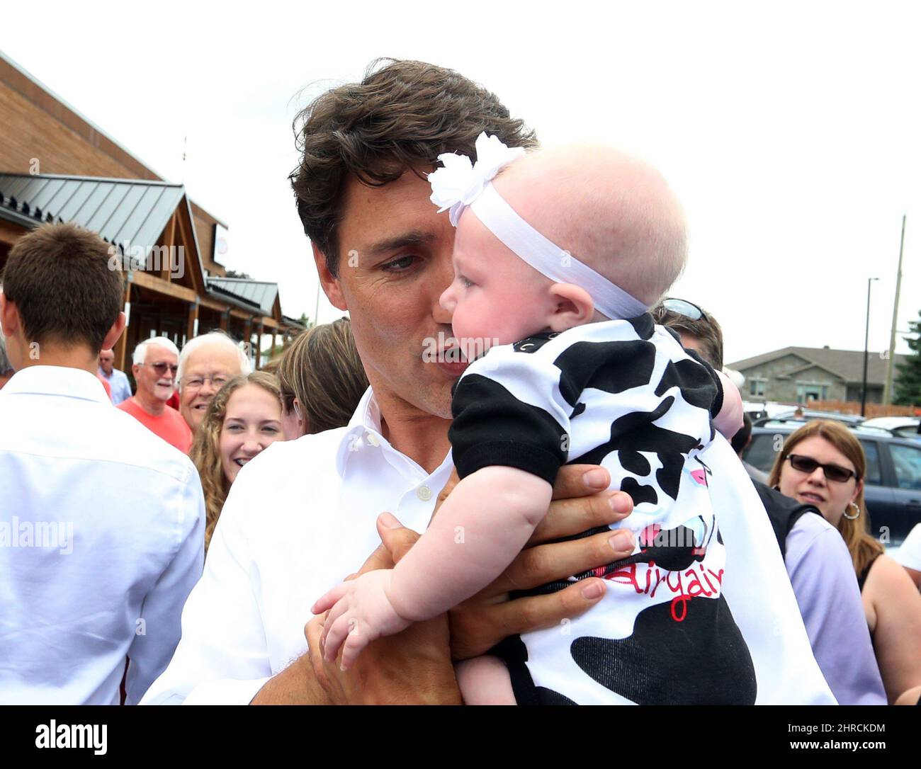 Prime Minister Justin Trudeau holds a baby as he visits the St-Albert ...