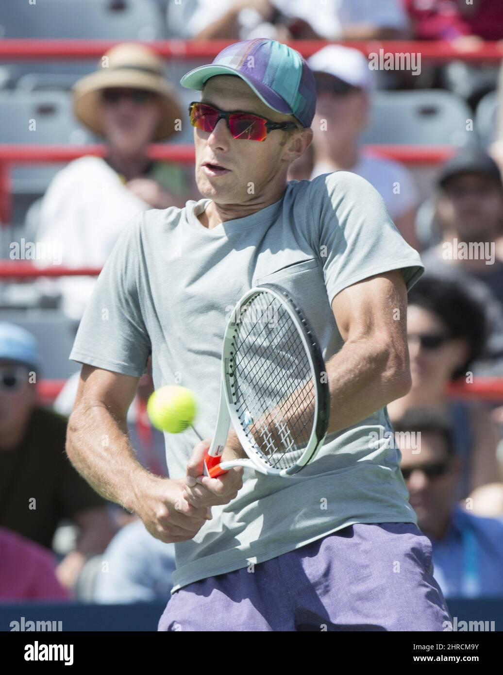 Peter Polansky of Canada returns to Roger Federer of Switzerland during ...