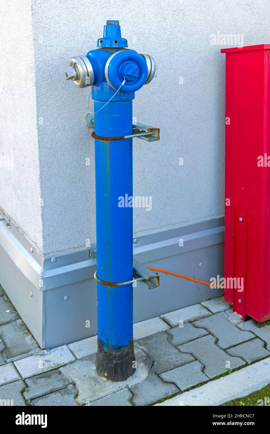 Blue Water Pipe Fire Hydrant With Rusty Holder Stock Photo - Alamy