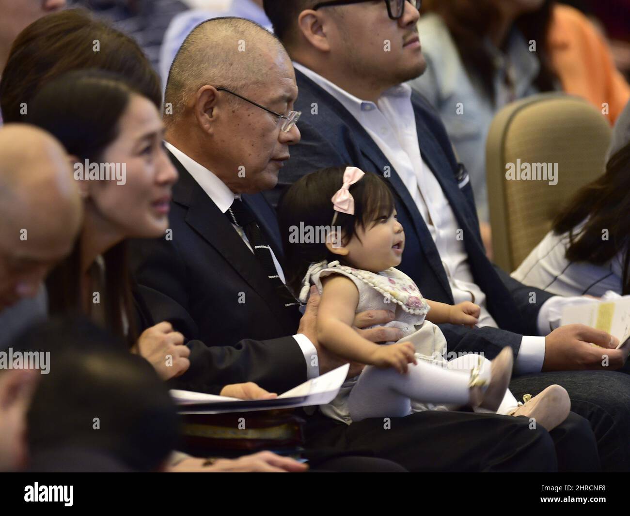 Pastor Hyeon Soo Lim holds his granddaughter during a church service at ...